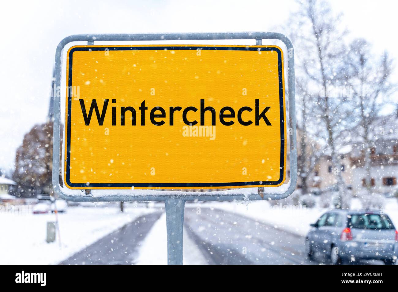17 January 2024: Winter check sign on a wintry road with heavy snowfall ...