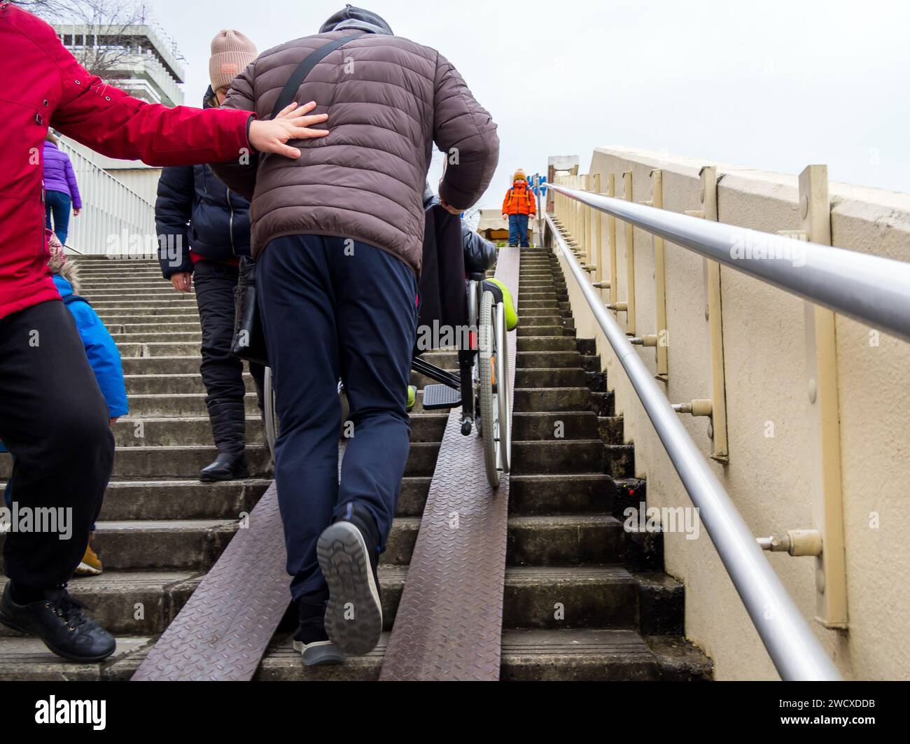 Child pushing wheelchair hi-res stock photography and images - Alamy