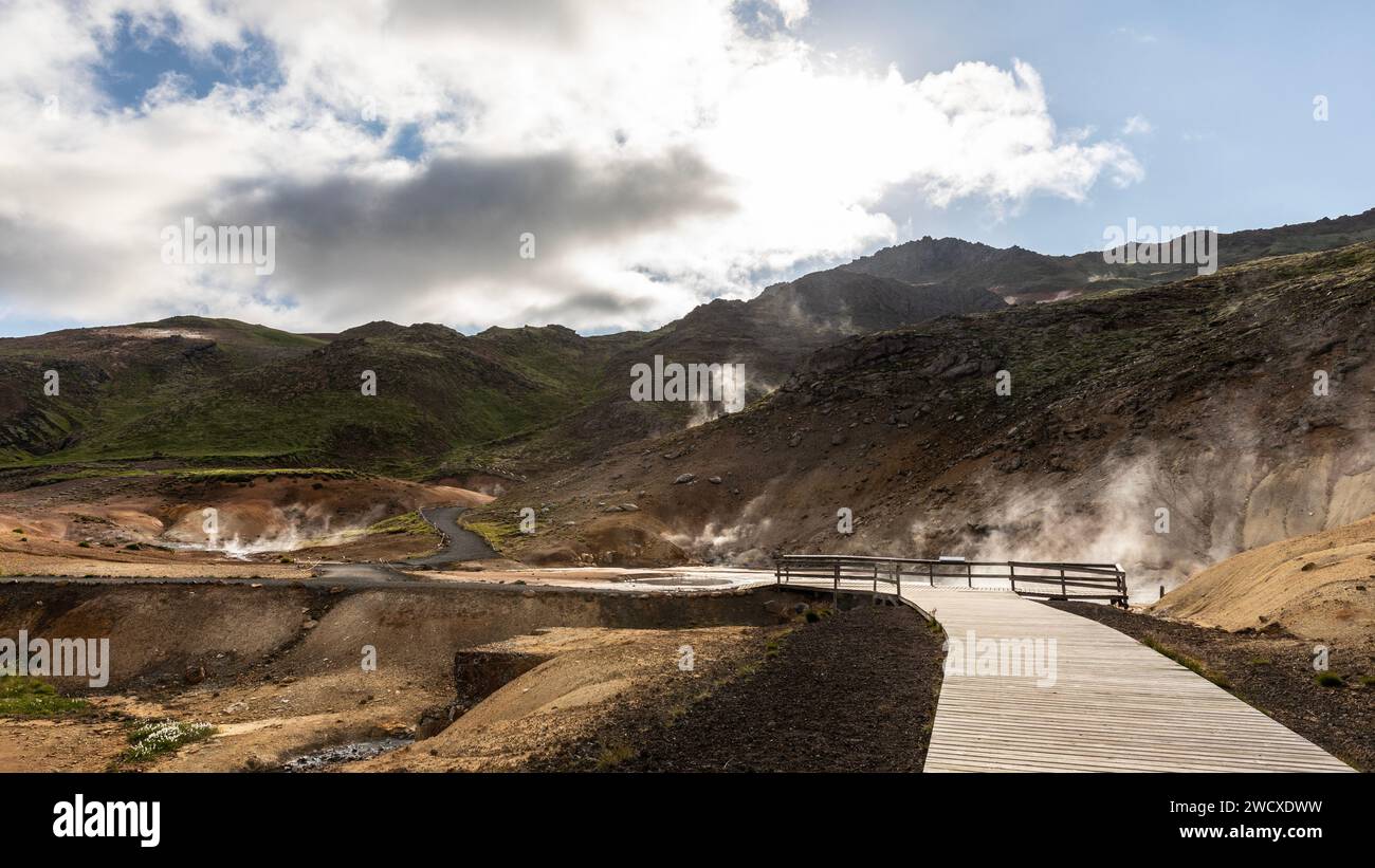 Hiking trail through the active Krysuvik geothermal area surrounded by ...