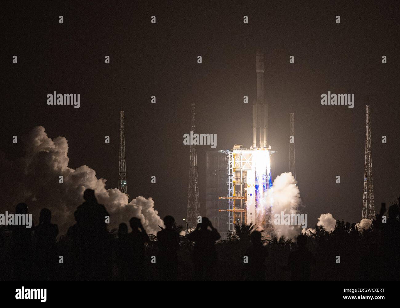 Wenchang. 17th Jan, 2024. People watch as a Long March-7 Y8 carrier ...