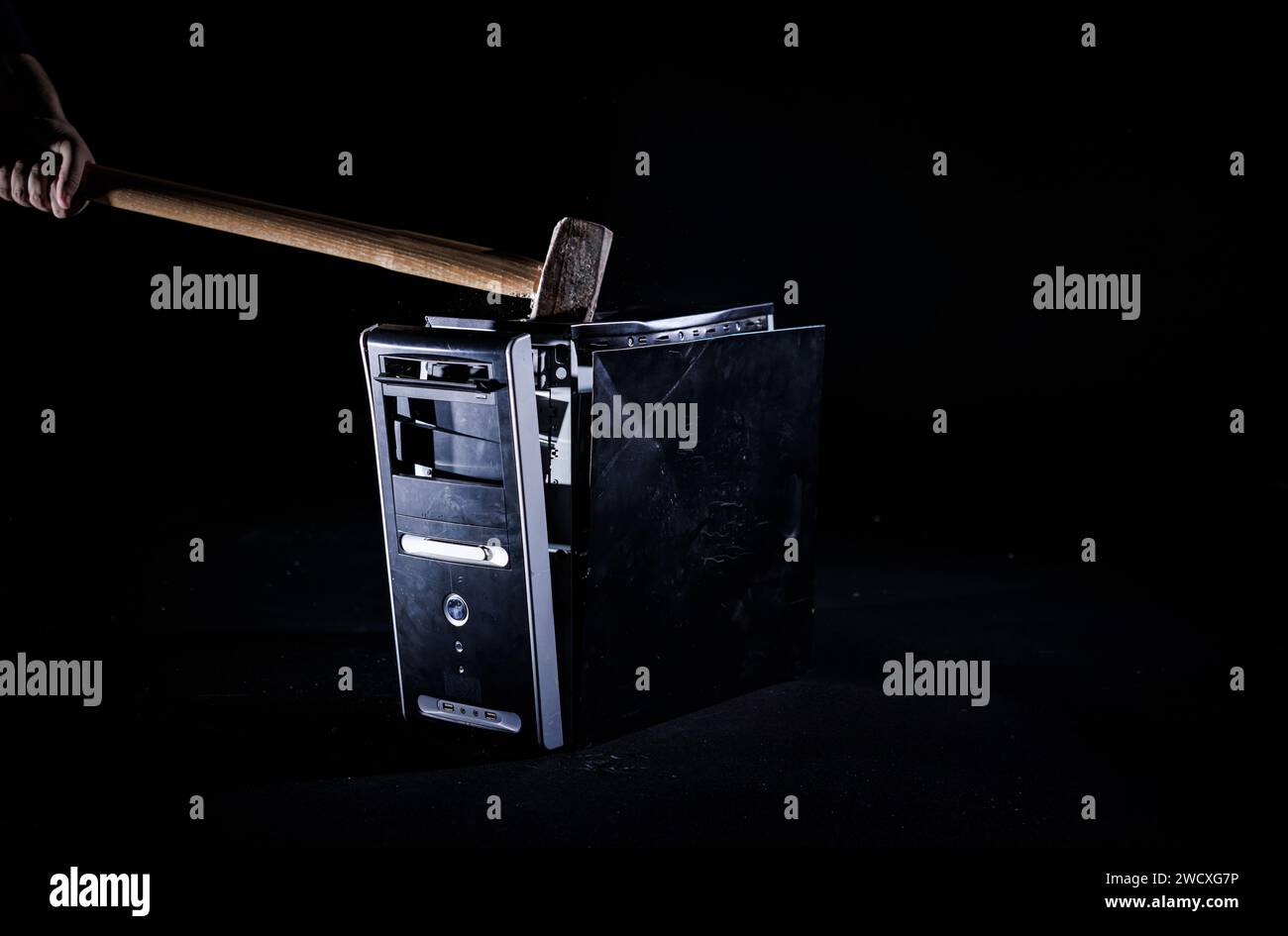 Blow of a large, heavy hammer with a long handle onto a desktop ...