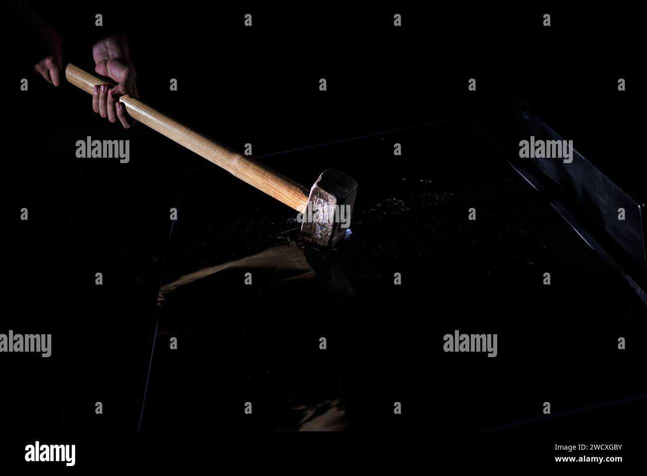 Man hitting a big flat TV screen with a sledgehammer, isolated on a ...