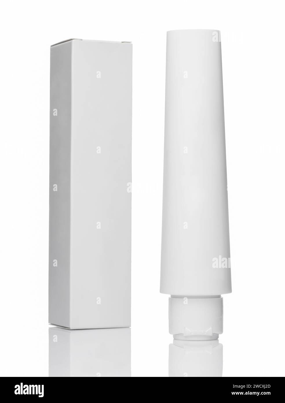White blank tube for cosmetics with white carton packaging on white ...