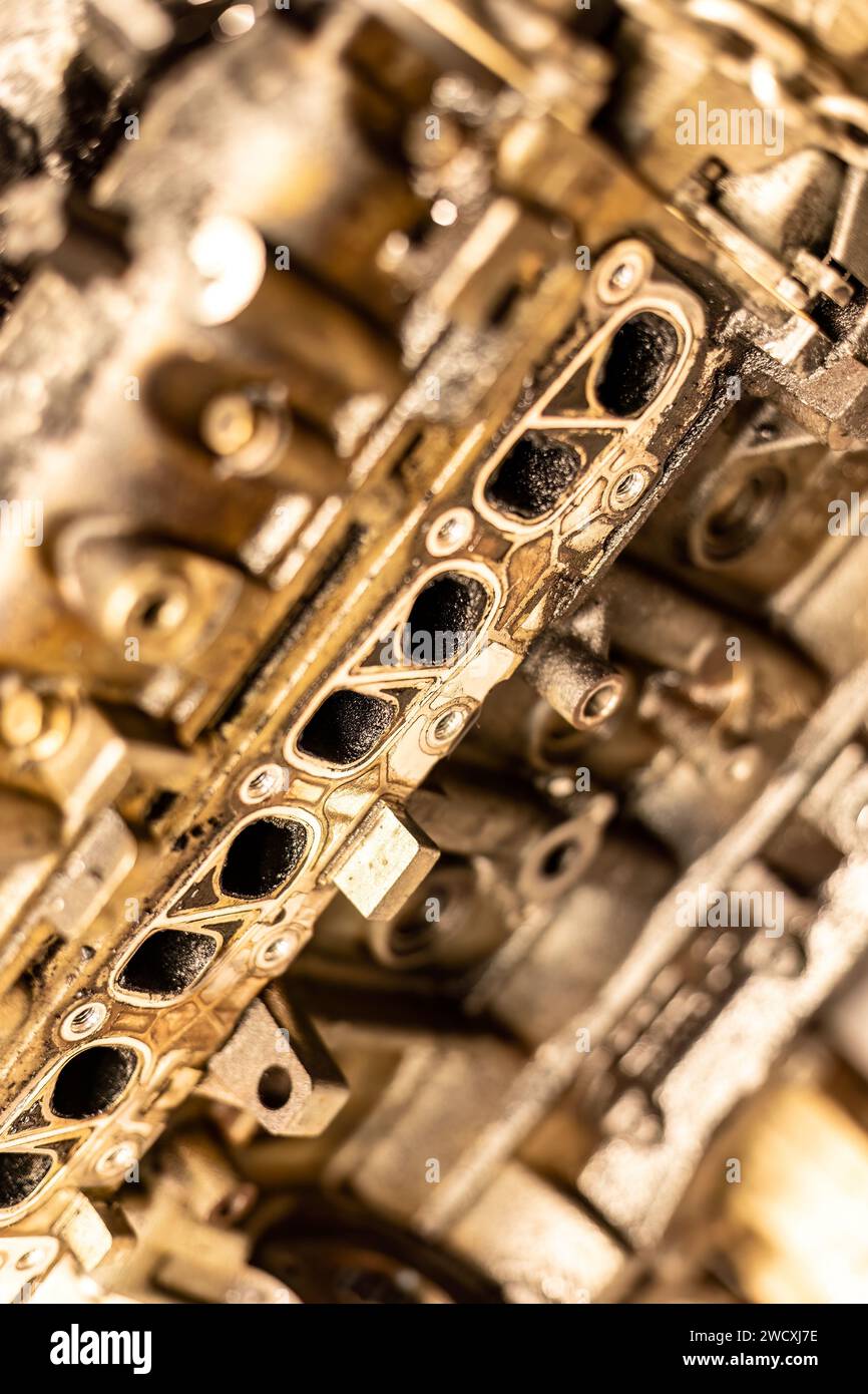 A photo showing dirty intake manifolds in a car engine, impacted by ...