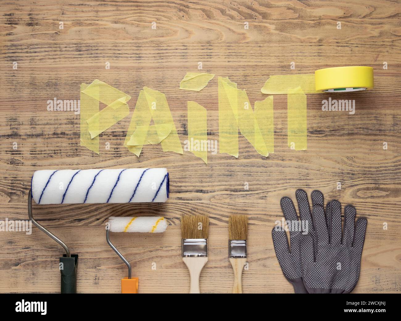 Painting tools on a wooden background with the word Paint made from ...