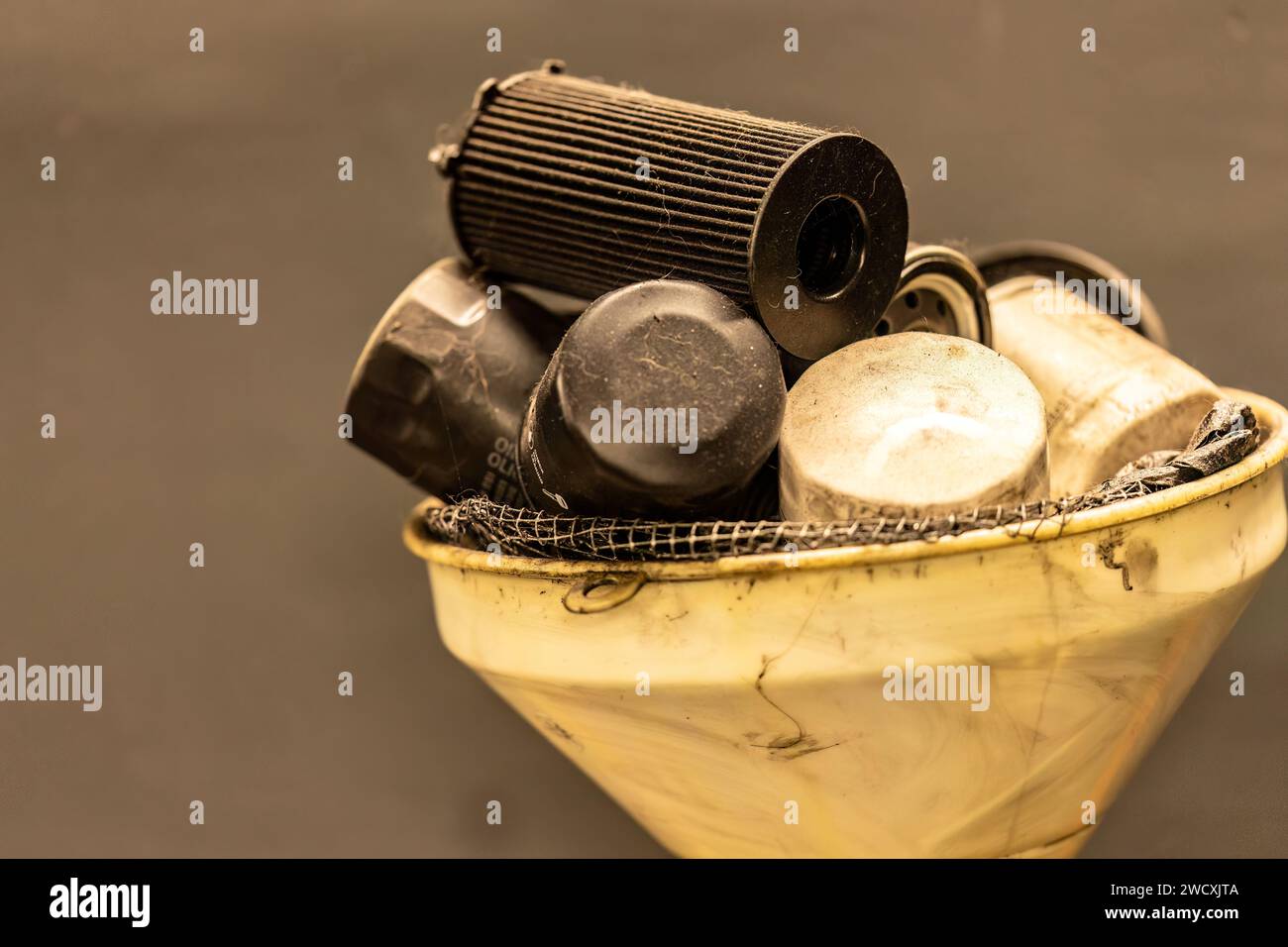 Photo of old, exhausted oil filters in a workshop, symbolizing ...