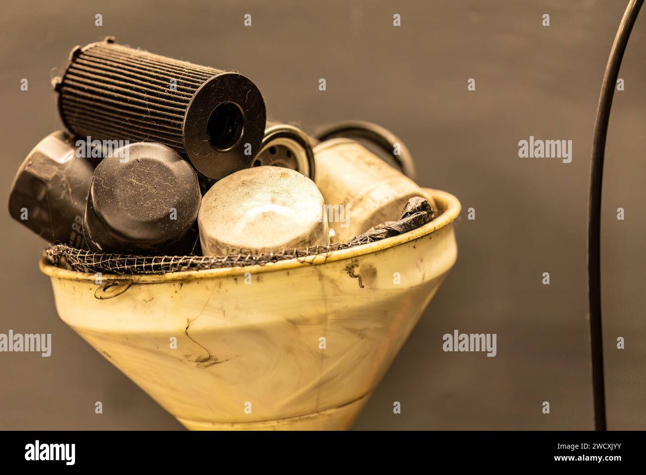 Photo of old, exhausted oil filters in a workshop, symbolizing ...