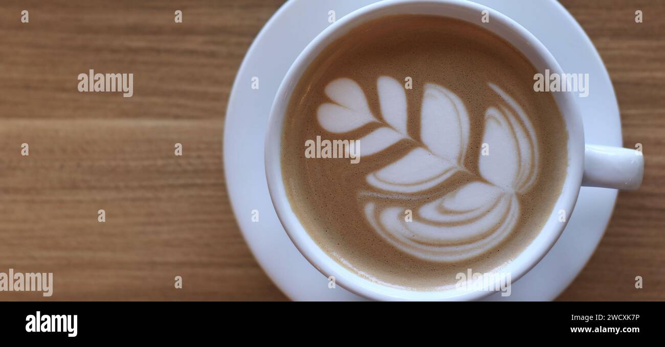 A top view of a comforting cafe latte cup with a leaf design Stock ...