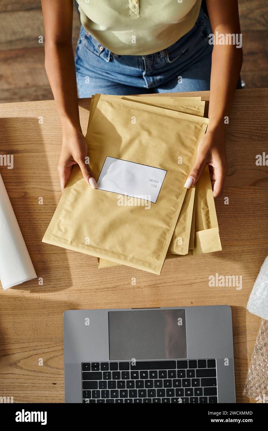 cropped view of young african american female merchant holding post ...