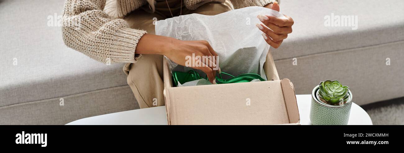 cropped view of young african american woman unboxing her parcel with ...
