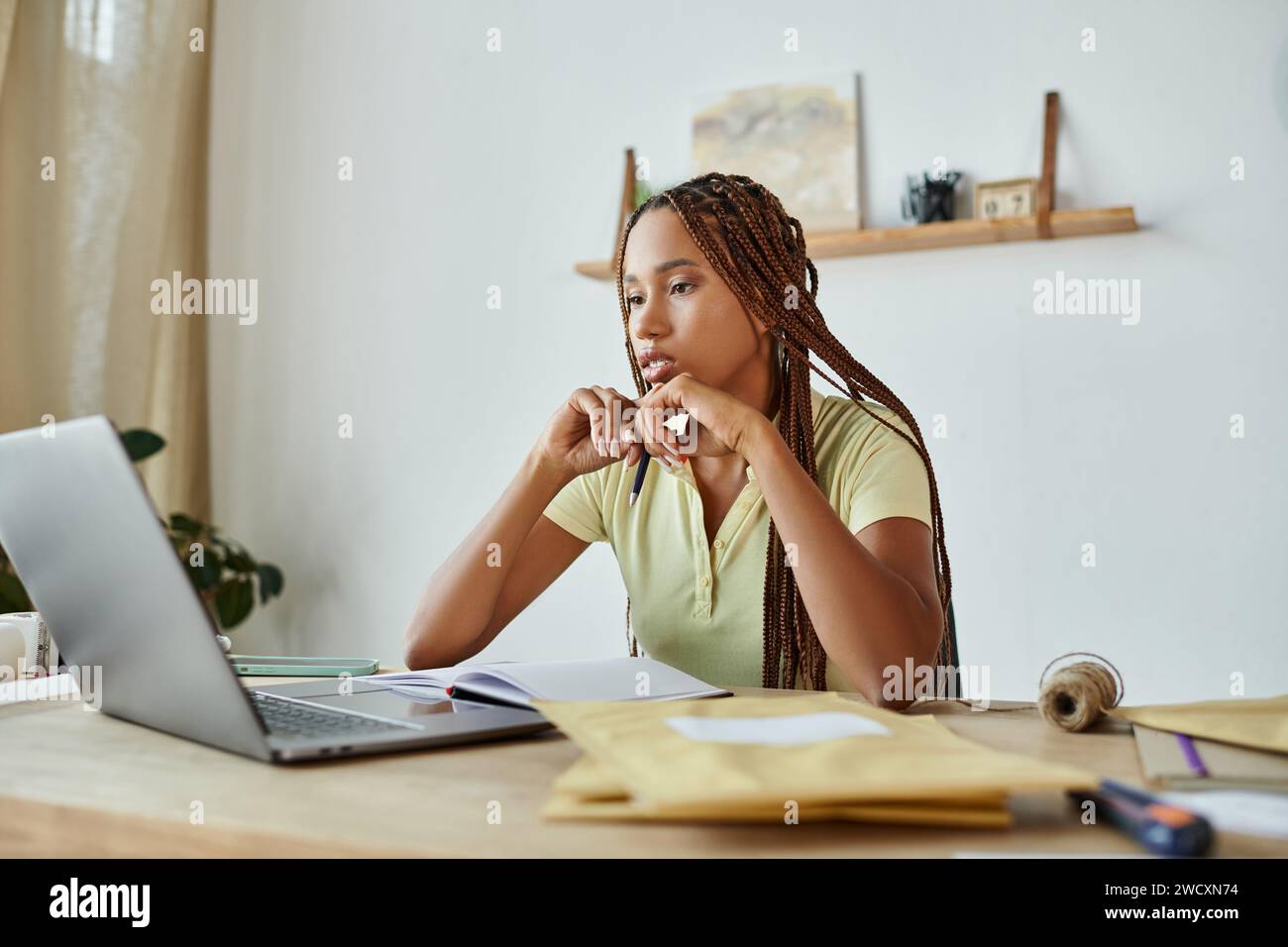 good looking african american female merchant looking at her laptop ...