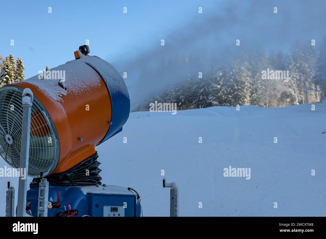 Snow cannon snowing the slope for the ski season - preparation in full ...