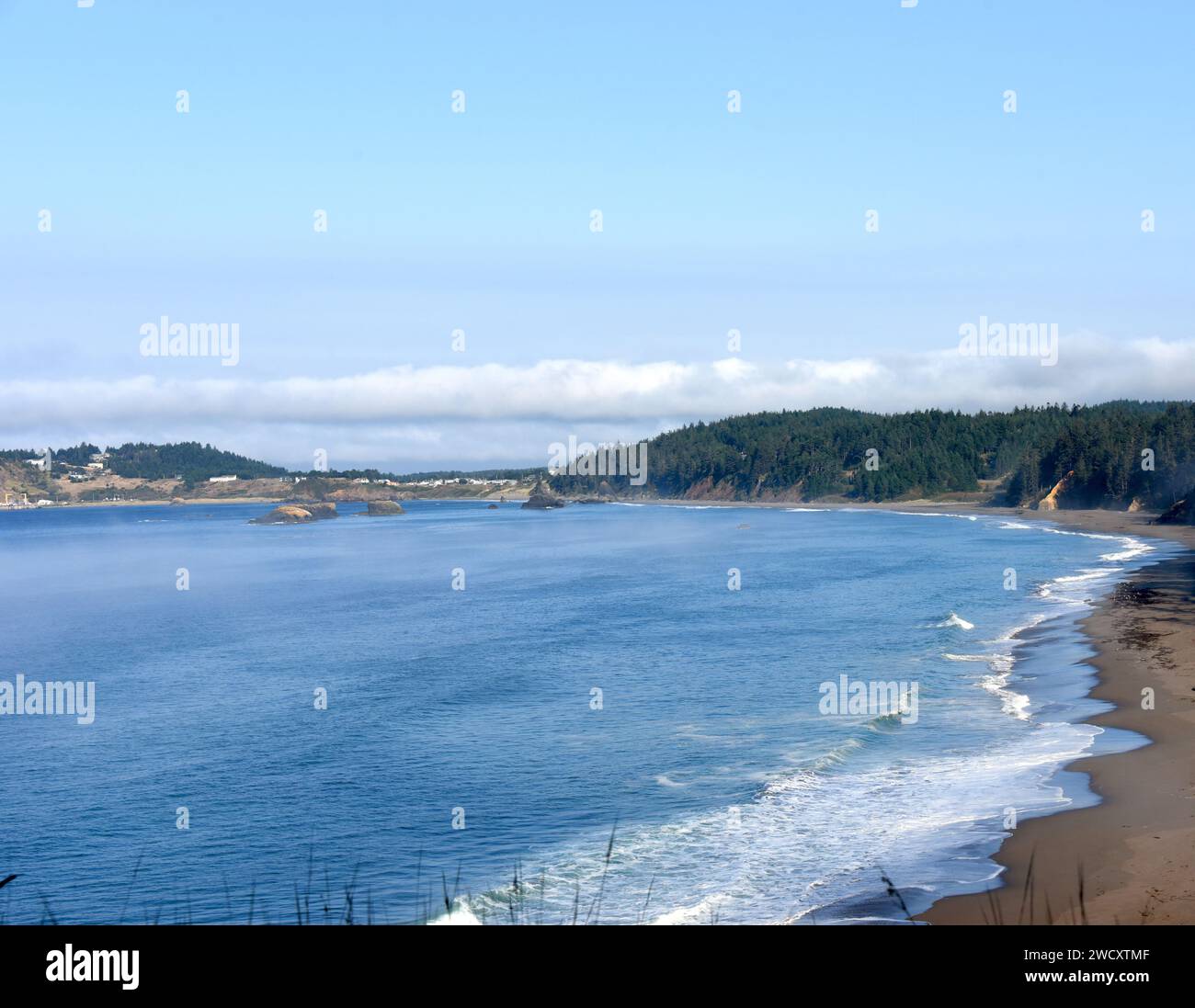 Port Orford Bay, in Oregon, has sea stacks and offshore islands. Water ...