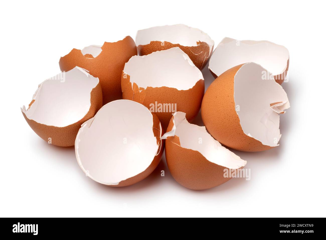 Heap of brown empty egg shells close up isolated on white background ...