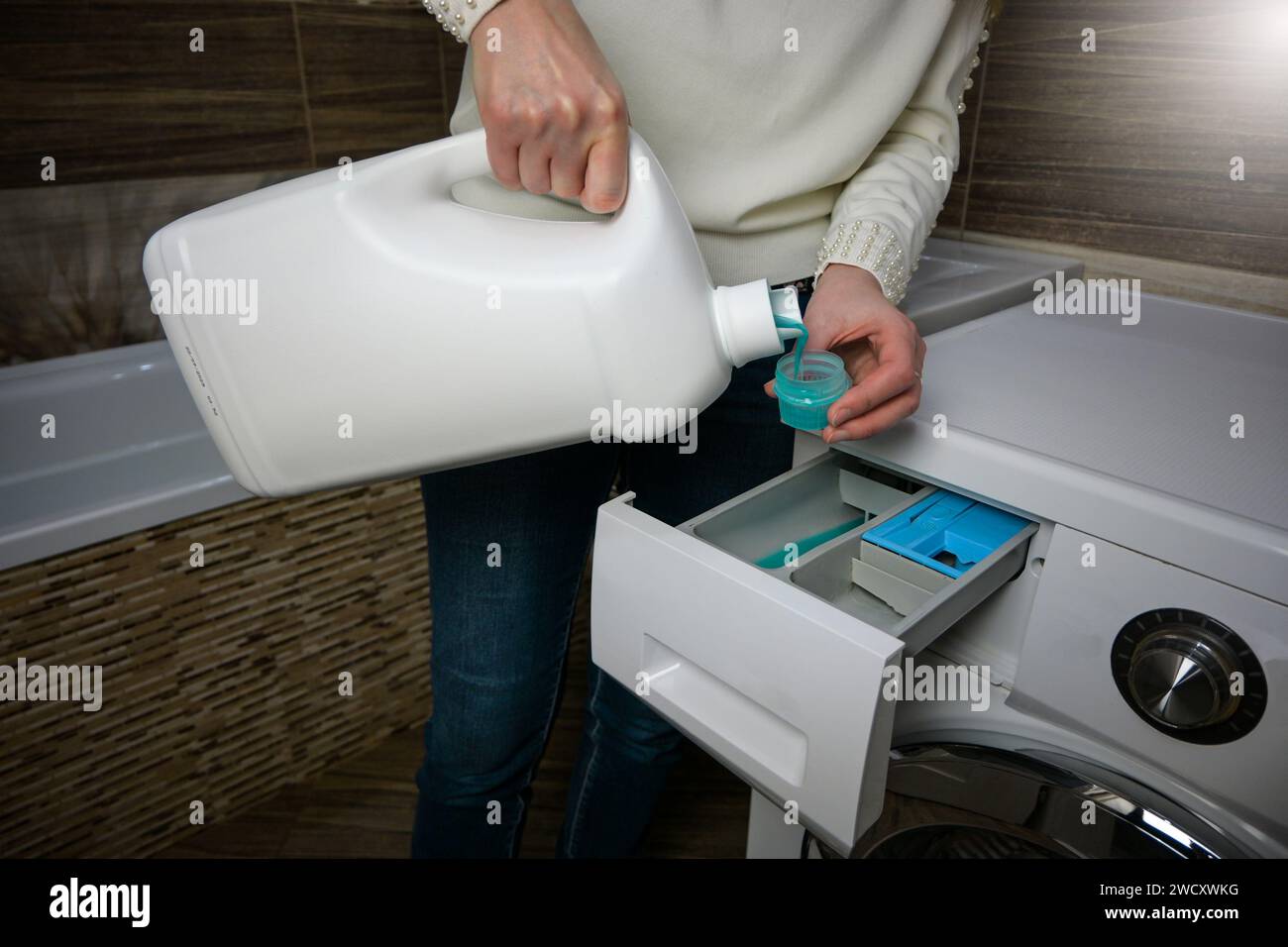 Pouring conditioner washing machine hi-res stock photography and images ...