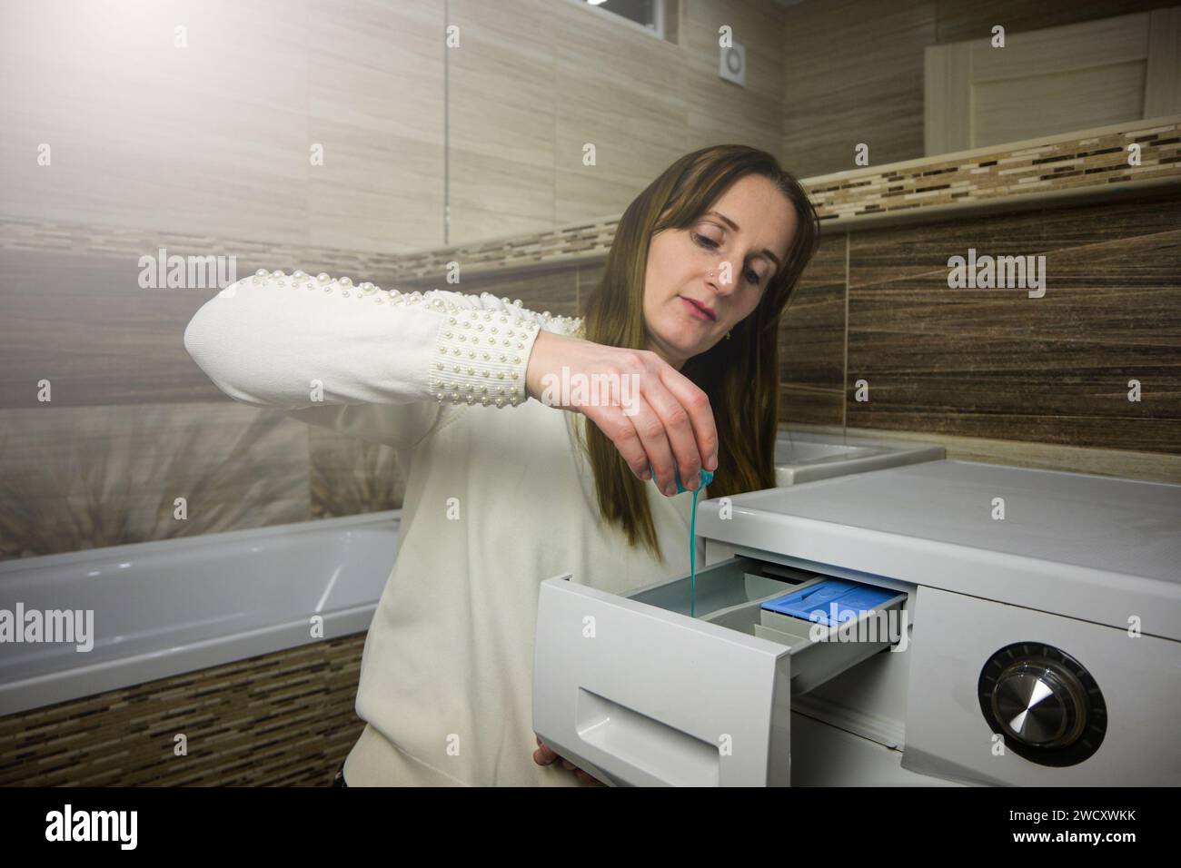 Woman with washing powder hi-res stock photography and images - Alamy