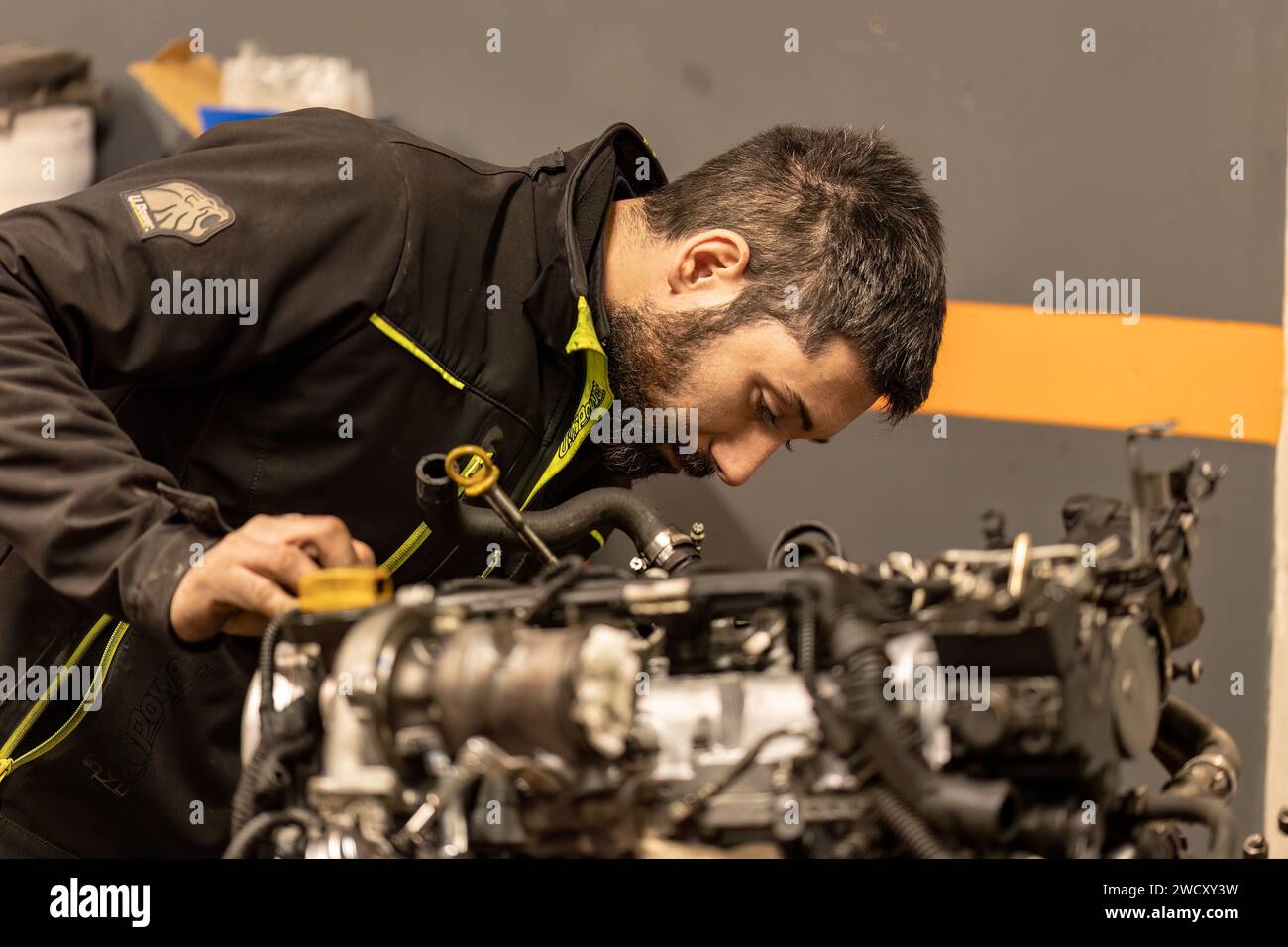 Rome, Italy 17 january 2024: A mechanic meticulously examining a car ...