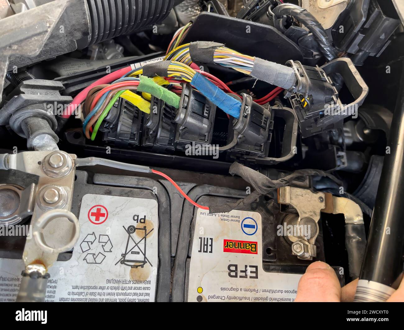 Milan, Italy 11 january 2024: Close-up of wires connected to the car's ...