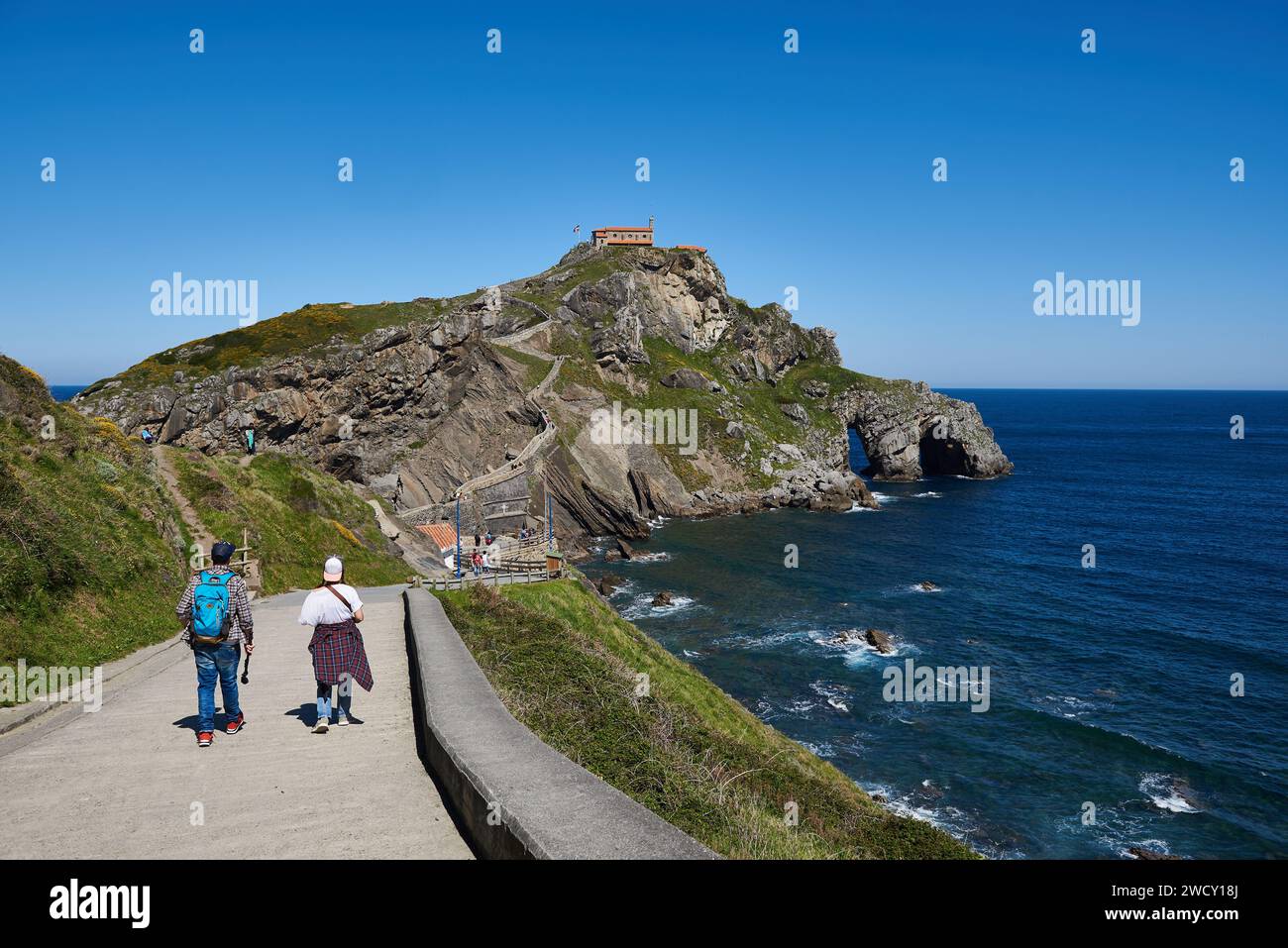 Tourist walking to San Juan de Gaztelugatxe, Bermeo, Biscay, Basque ...