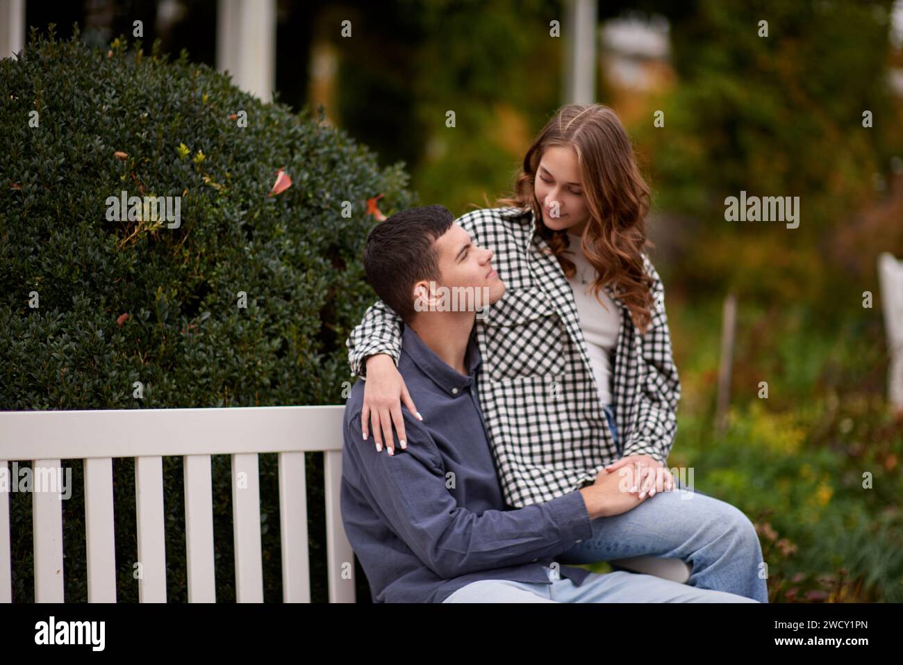 Autumn Romance: Young Couple Embracing and Kissing on Park Bench. Young ...