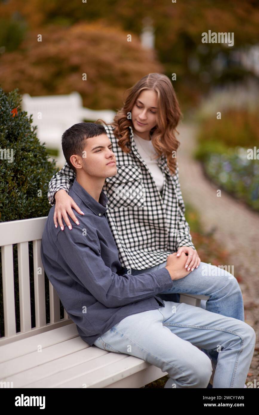 Autumn Romance: Young Couple Embracing and Kissing on Park Bench. Young ...