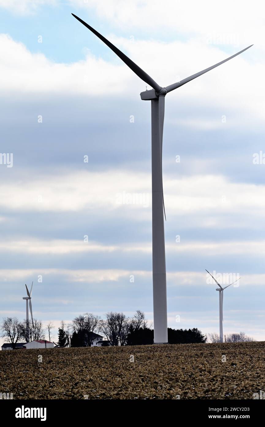 Lee, Illinois, USA. Wind turbines tower above a farm in rural northern ...