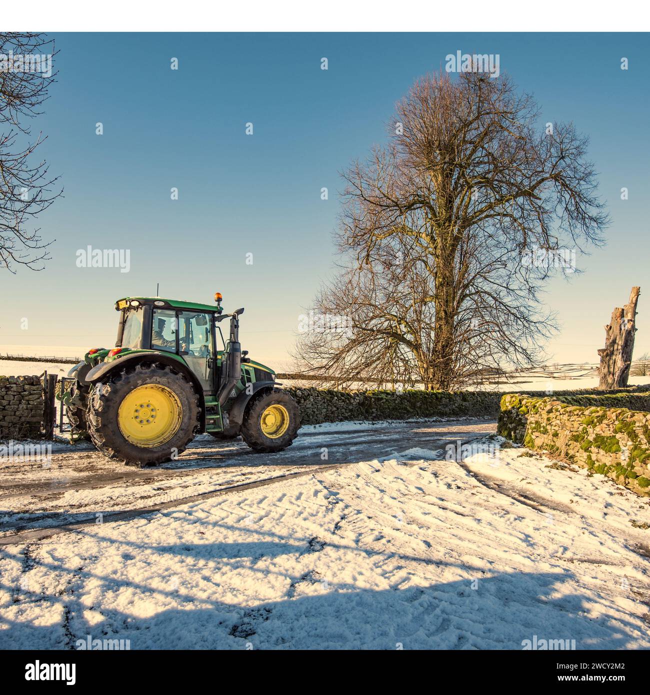 Young farmer on his return tractor journey after taking a trailer load ...
