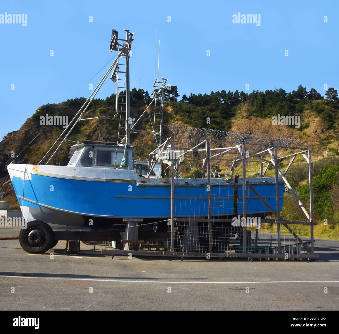 Blue, weathered boat is dry docked at one of only two "Dolly Docks" in ...