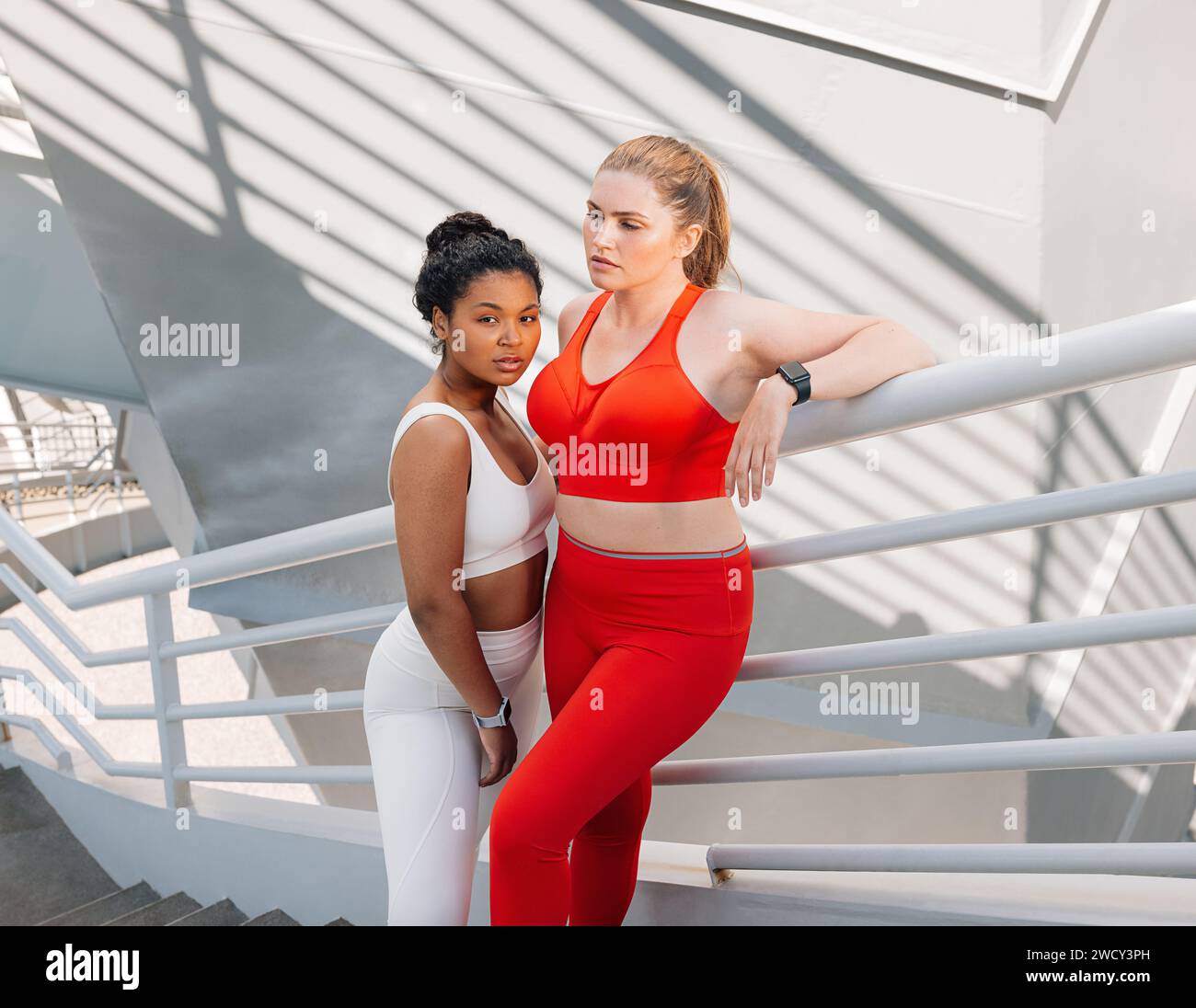 Two plus-size women standing at the railing relaxing after an intense ...