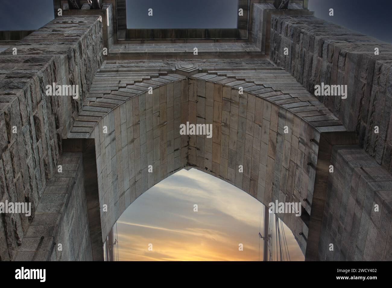 Looking up at a Brooklyn Bridge tower and arch made from limestone and ...