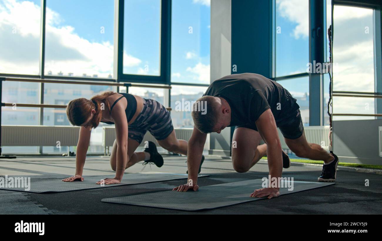 Caucasian sportsman man sportswoman woman sporty bodybuilders doing ...