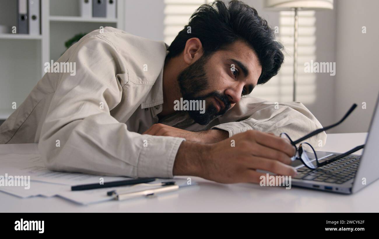 Lazy weary sleepy male manager tired exhausted Arabian Indian ...