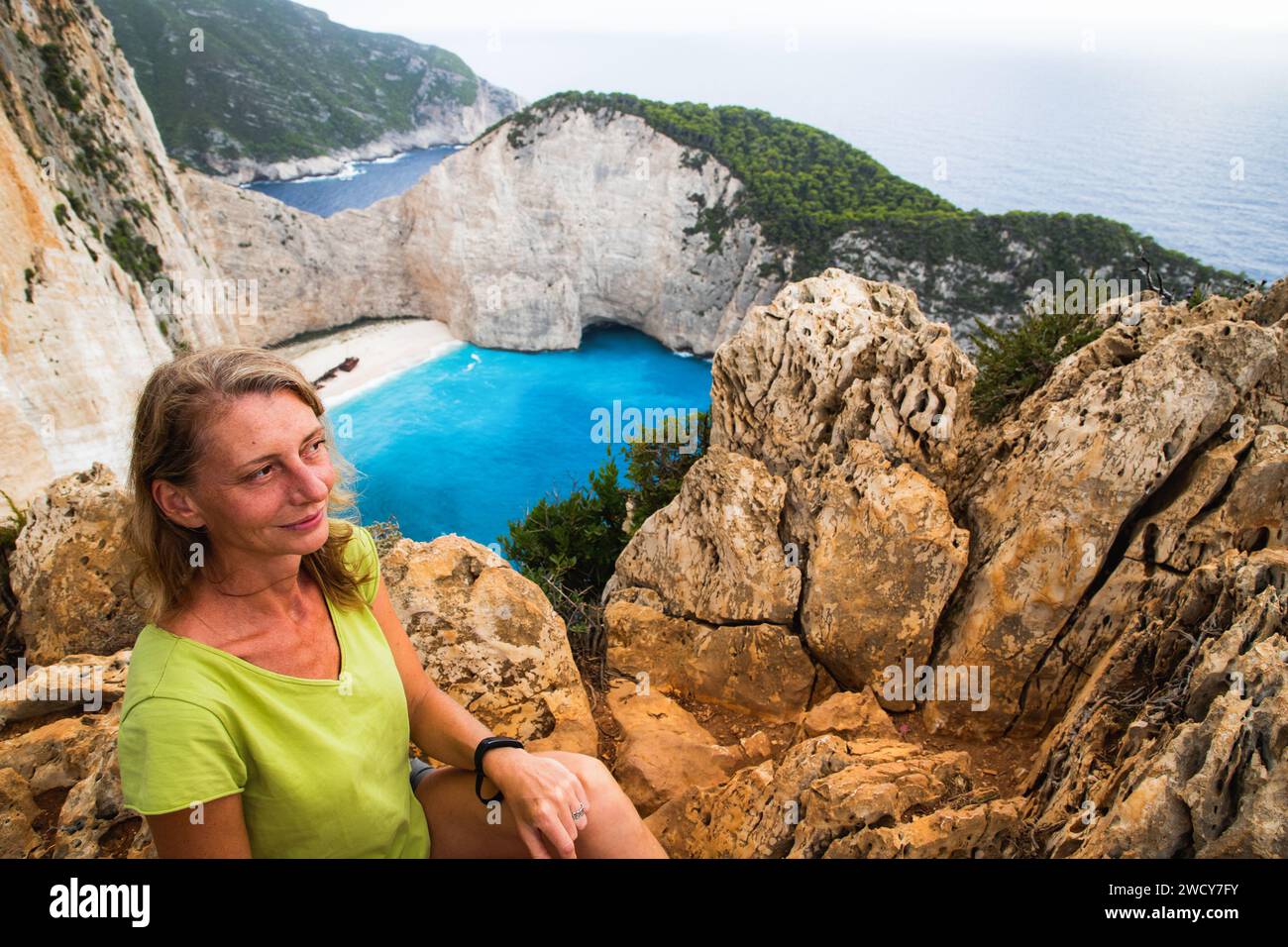 woman looking at Navagio beach with the famous wrecked ship in Zante ...