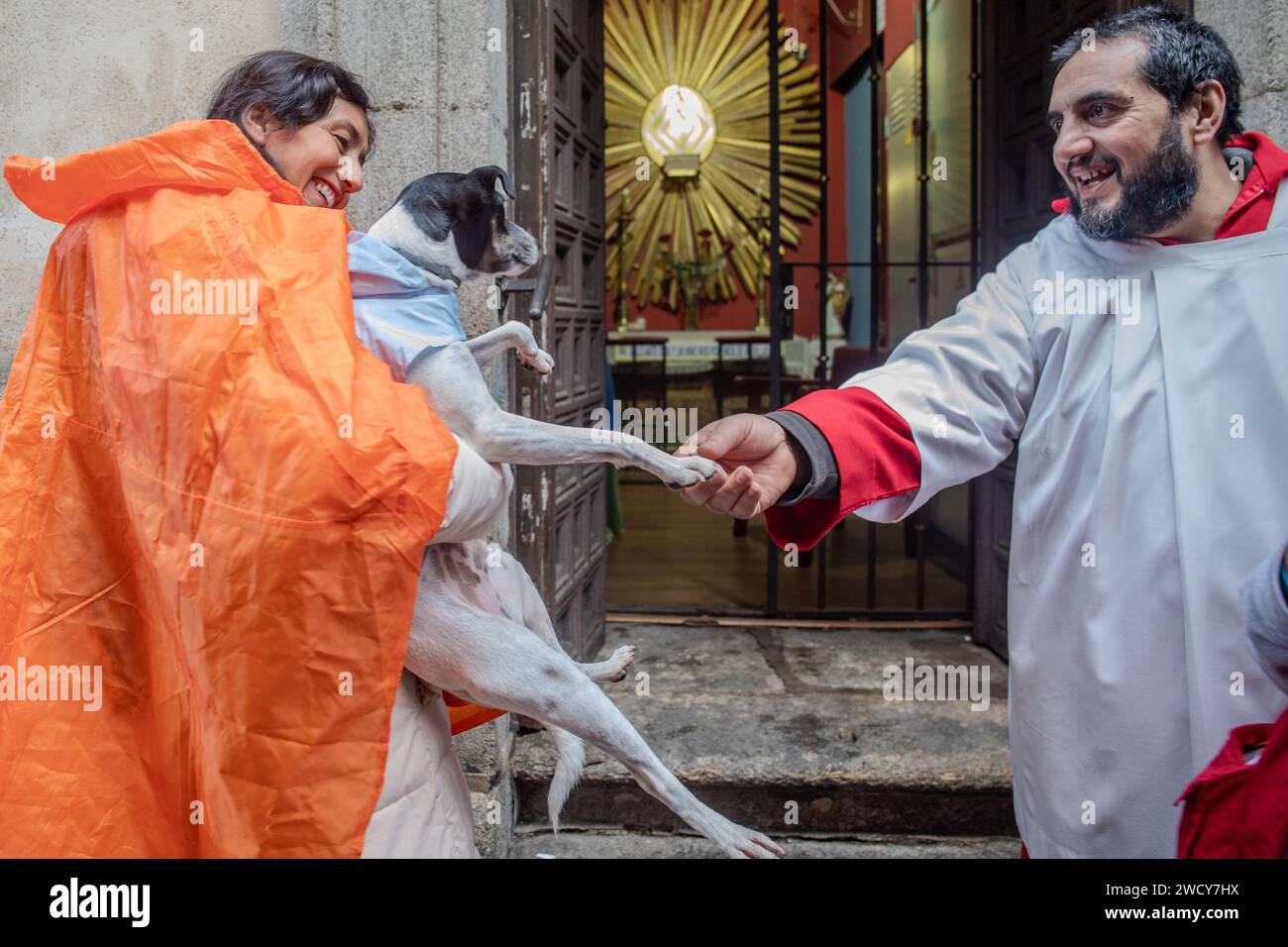 Madrid, Spain. 17th Jan, 2024. A priest shakes hands with a dog in the ...