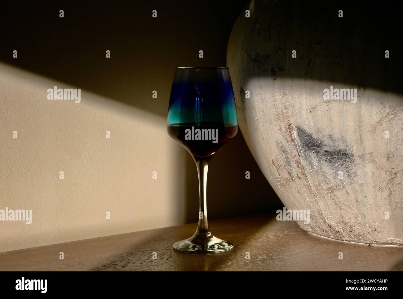A glass of red wine, lurking in the shadows Stock Photo - Alamy
