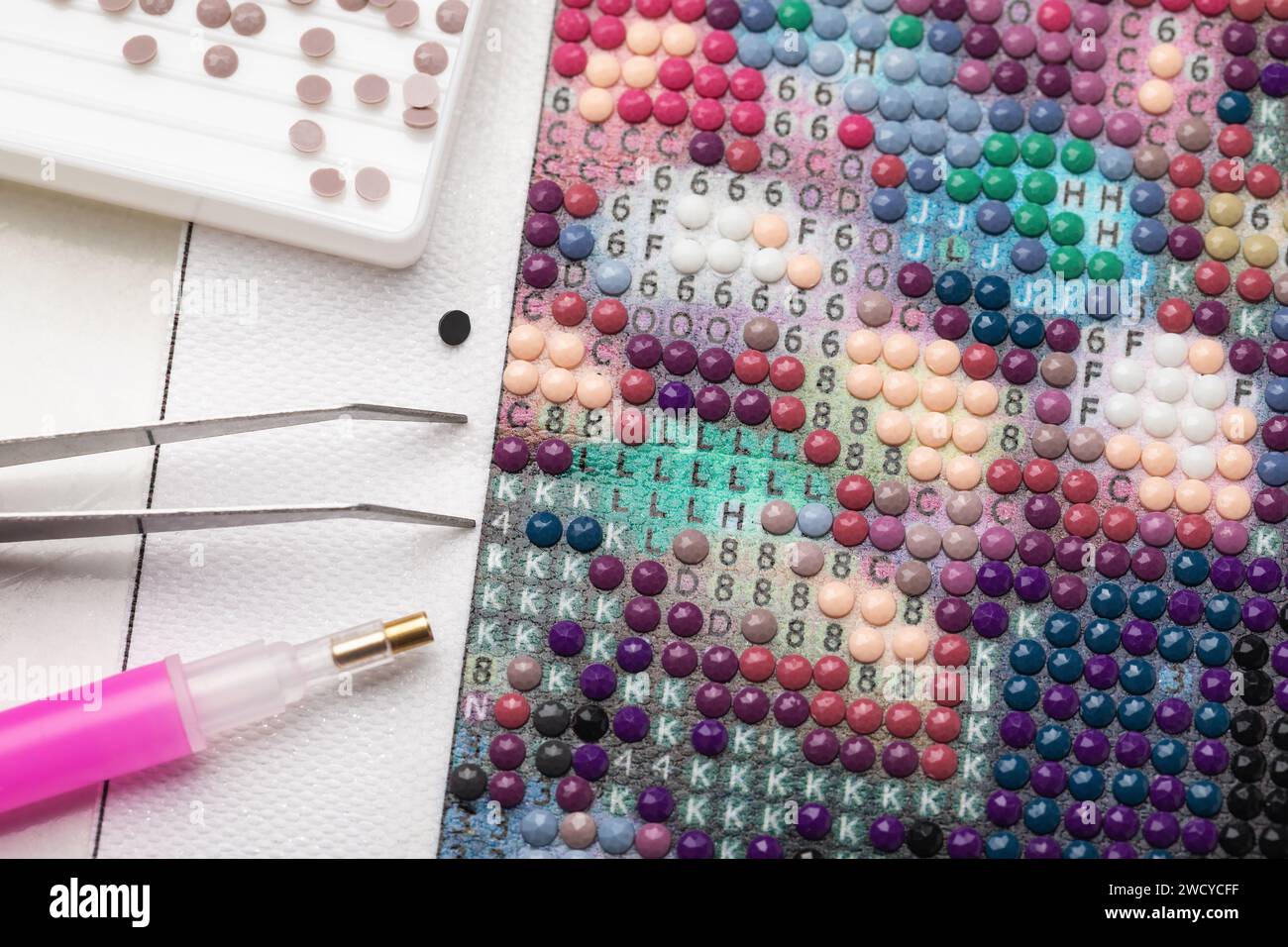 Tools for assembling a picture from small parts by numbers, top view of ...