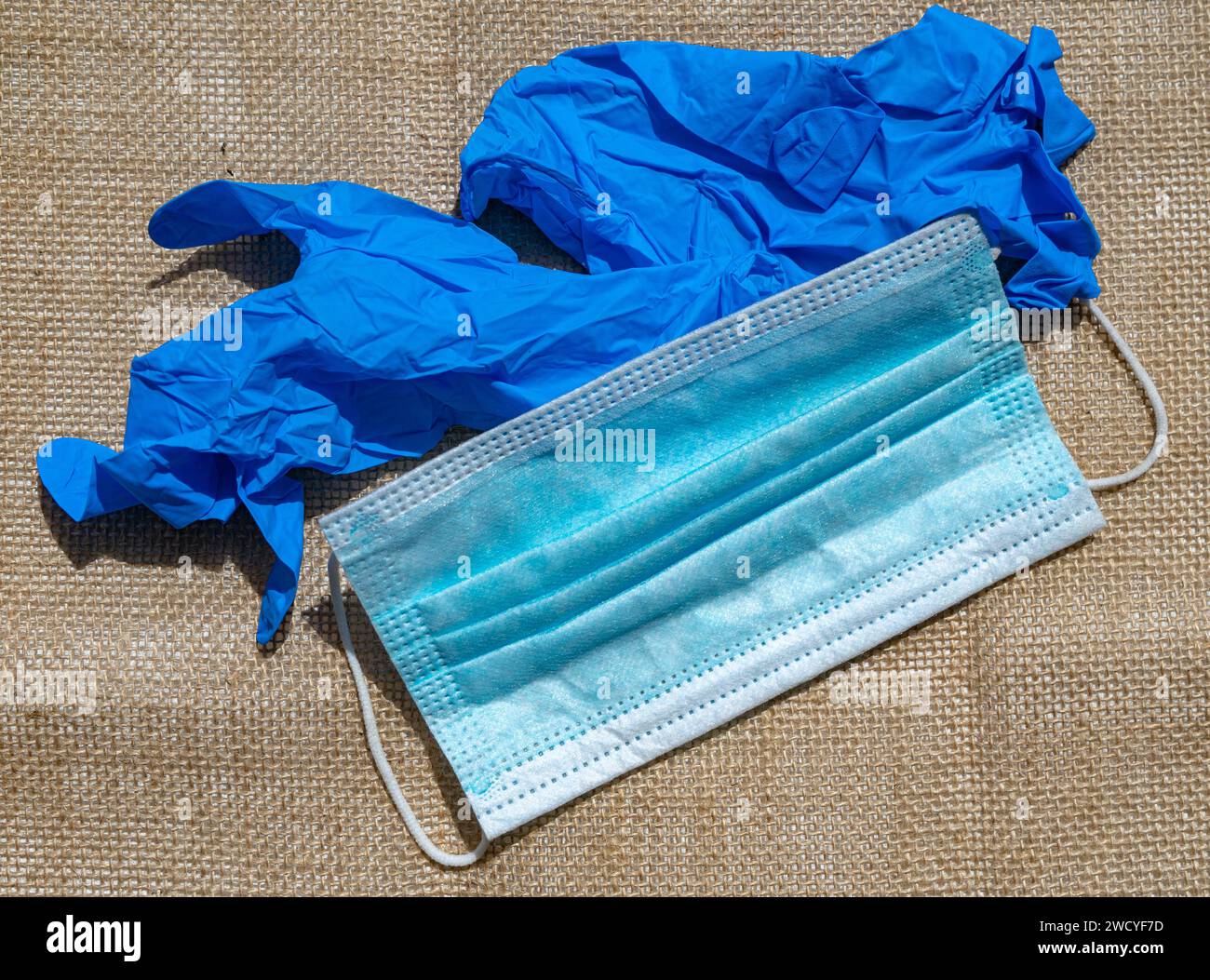 Disposable surgical face mask and surgical gloves are used to protect ...