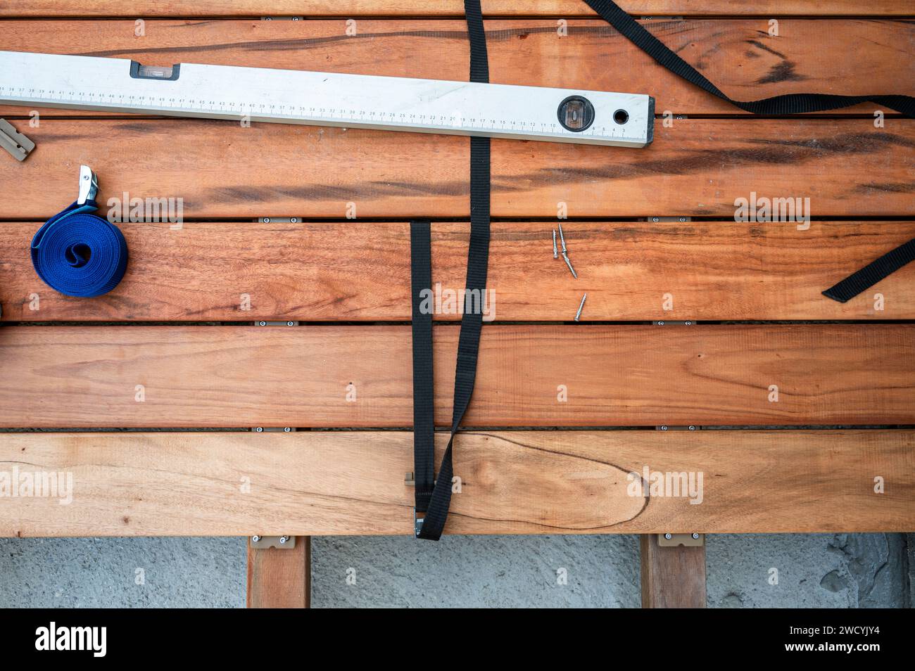 Top view of a water level scale, screws and fixating rope placed on ...