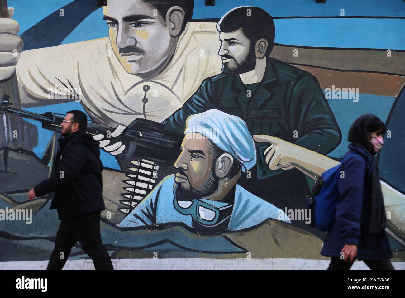 Tehran, Iran. 17th Jan, 2024. An Iranian man and woman walk past a ...