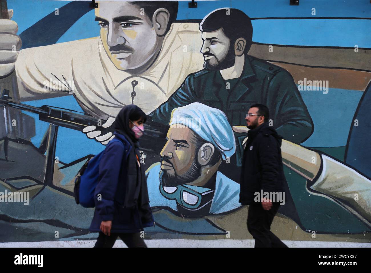 Tehran, Iran. 17th Jan, 2024. An Iranian man and woman walk past a ...
