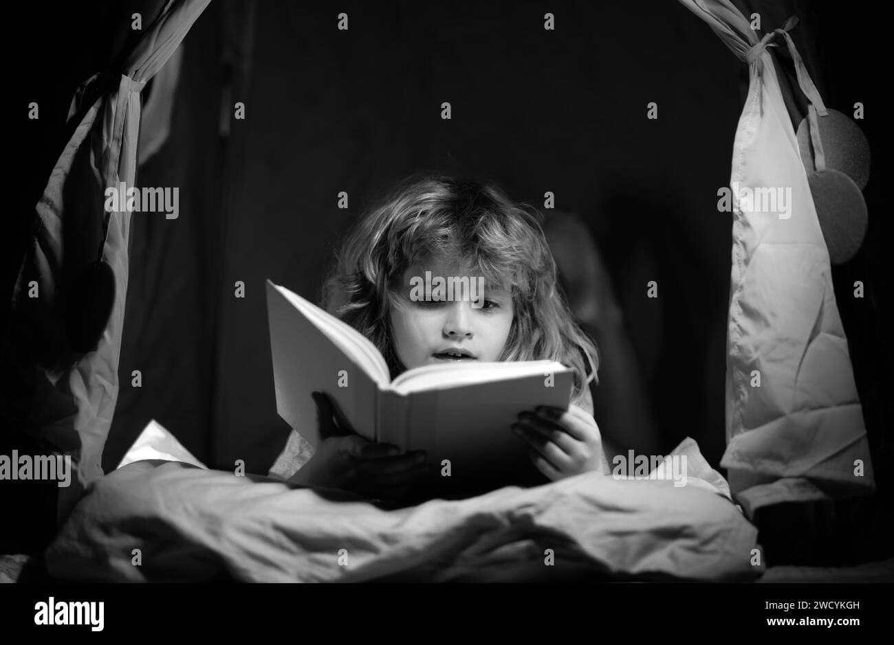 Child reading book. Kids bedtime. Boy read book in bed Stock Photo - Alamy