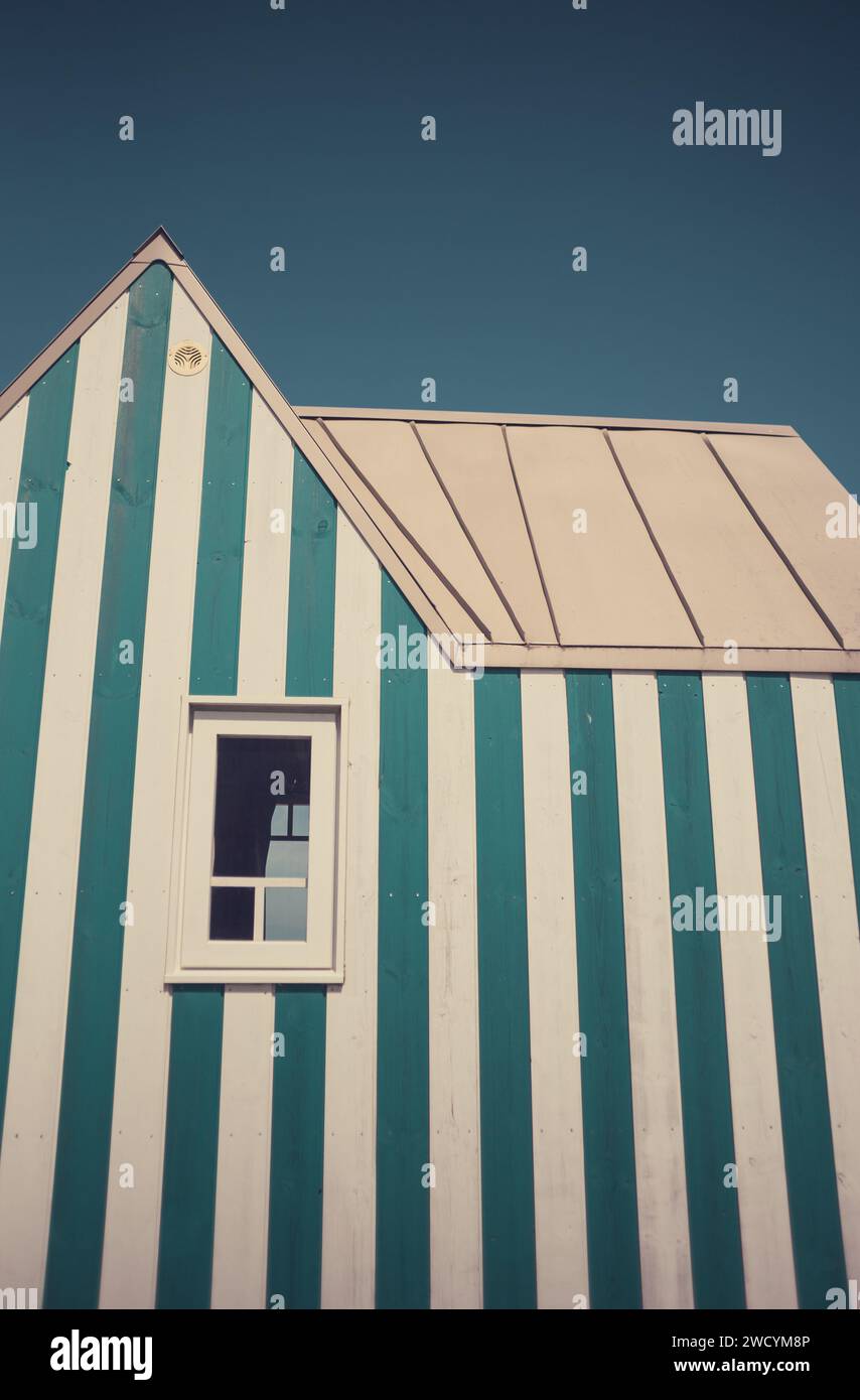 Little blue and white striped tiny house, close to the coast ...