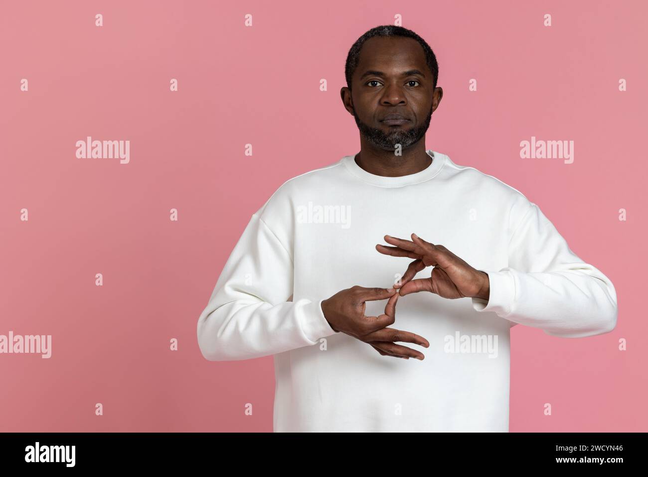 Deaf mute black man wearing white sweatshirt gesturing sign language ...