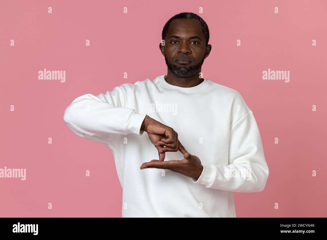 Black man wearing white sweatshirt using sign language Stock Photo - Alamy