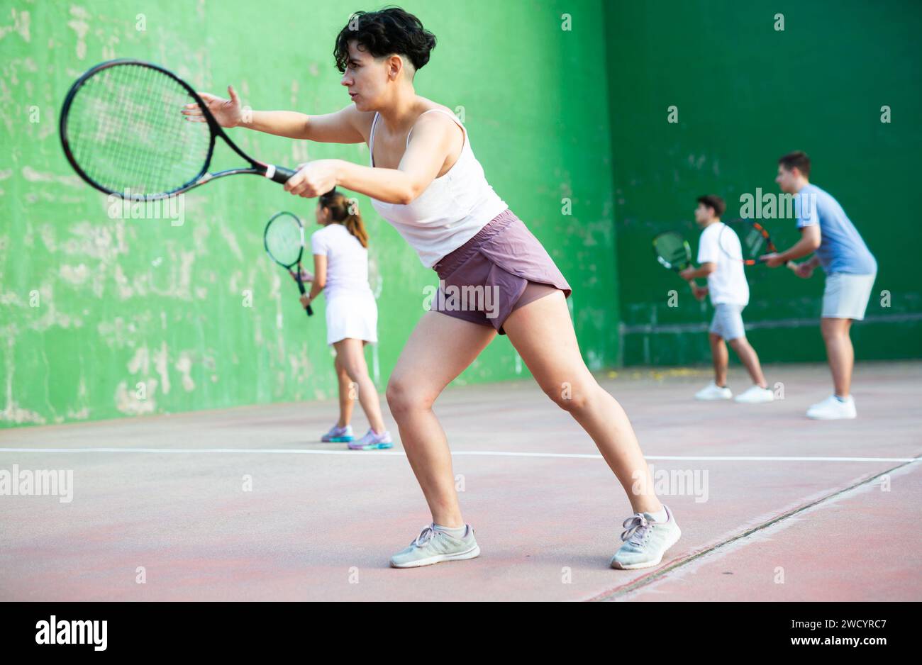 Woman serving ball during frontenis game outdoors Stock Photo - Alamy