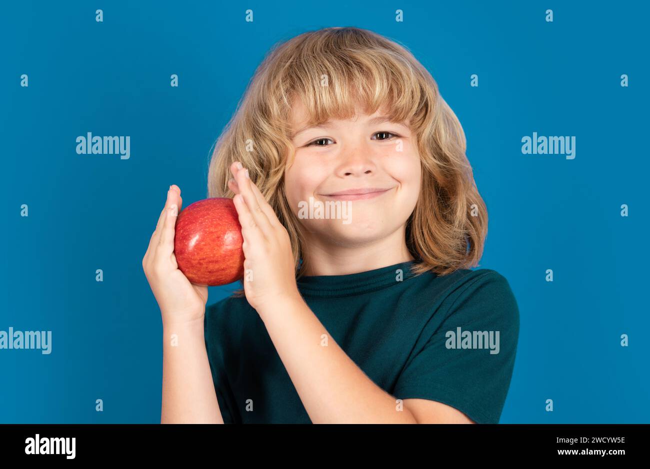 Red apple. Happy smiling child girl hold apple, health. Studio portrait ...