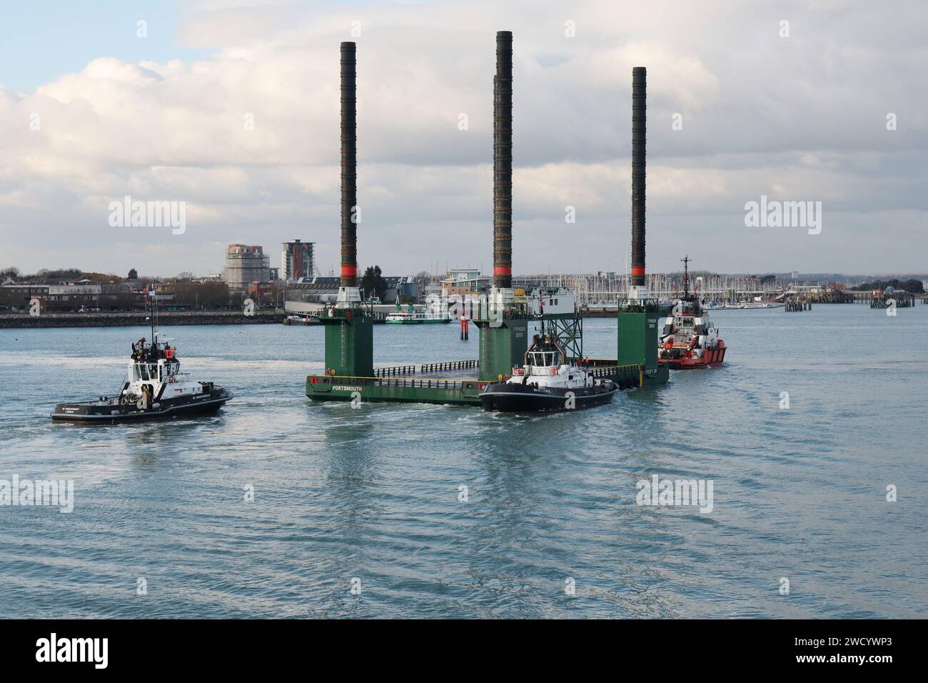 Tugs manoeuvre the BAE Systems operated jack up barge TYPHOON 3000 ...
