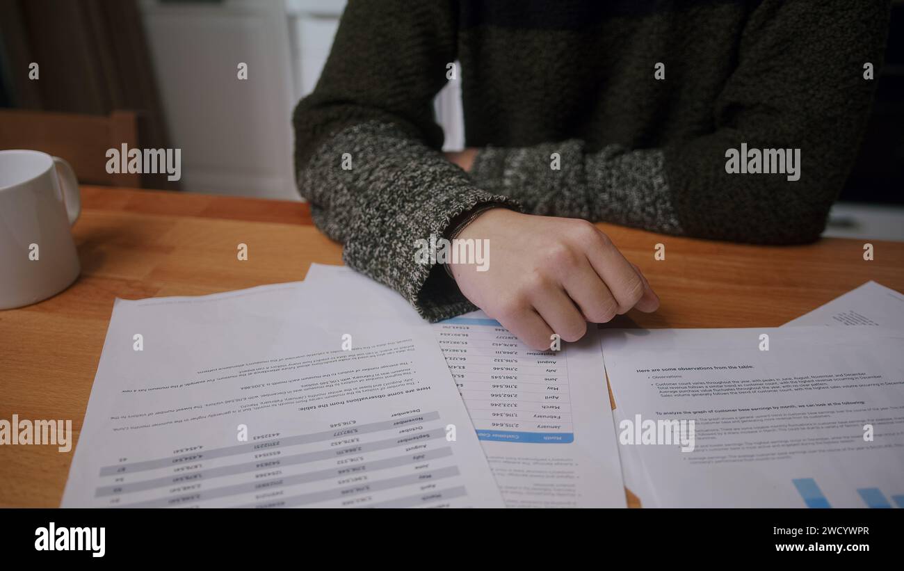 A young blonde student man sitting in a modern kitchen, talking to the ...