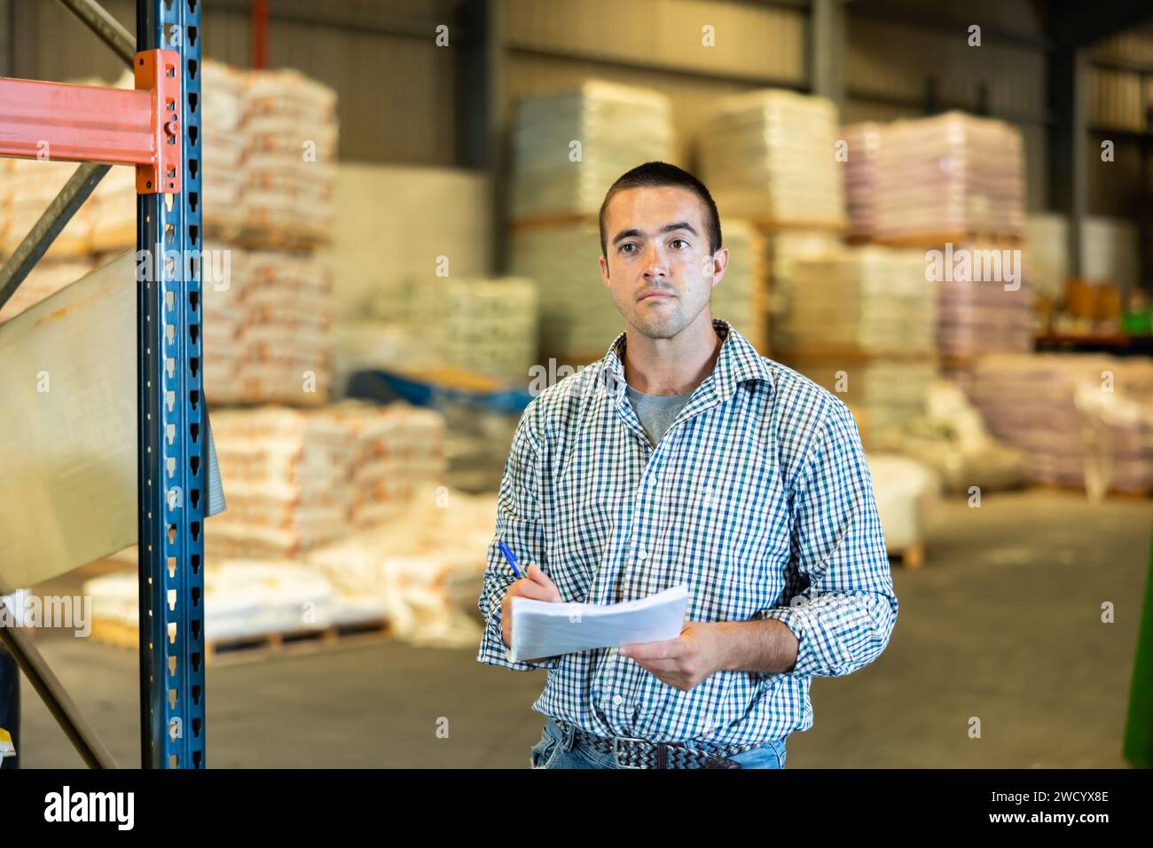 Man making stock control in warehouse Stock Photo - Alamy