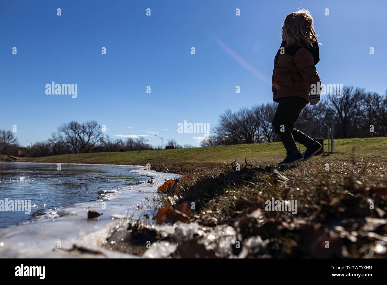 Denton, Texas, USA. 17th Jan, 2024. Ice frozen over a pound located at ...